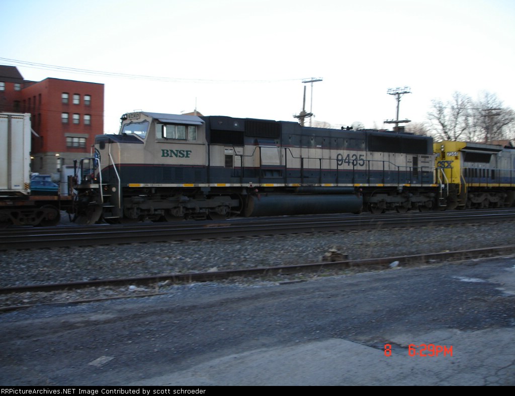 BNSF 9435 (SD70MAC) in cream & forest green paint heads EB into DeWitt Yard